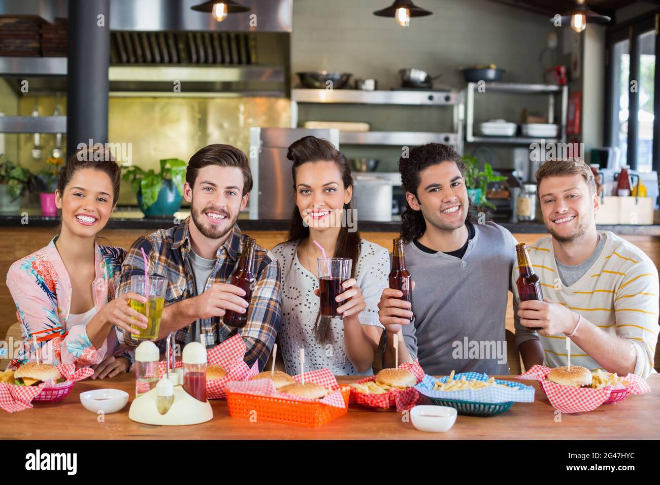 Cheerful friends holding beer hi-res stock photography and images - Alamy