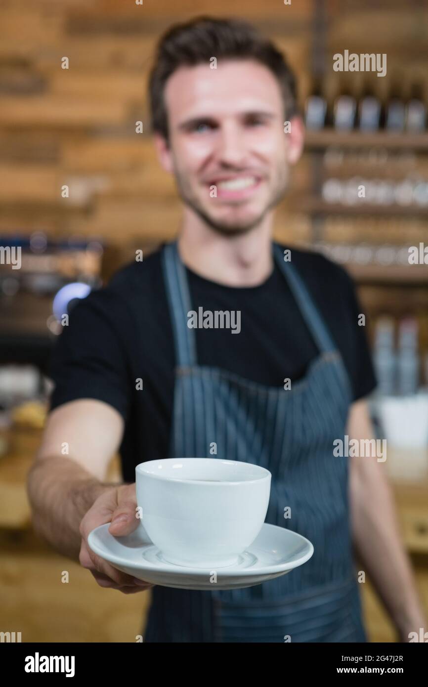 Business man offering cup hi-res stock photography and images - Alamy