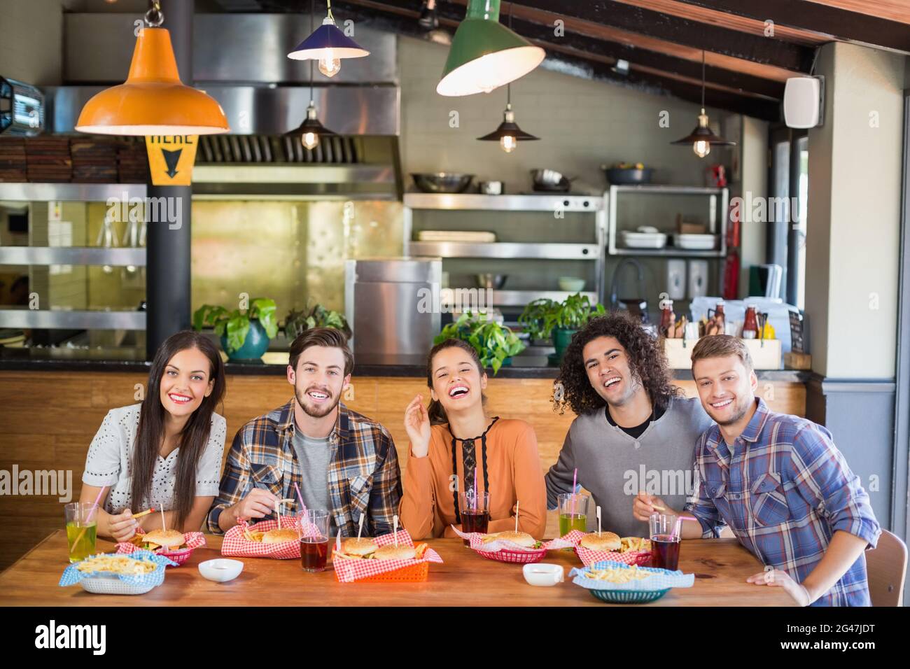 Friends enjoying food in restaurant Stock Photo - Alamy