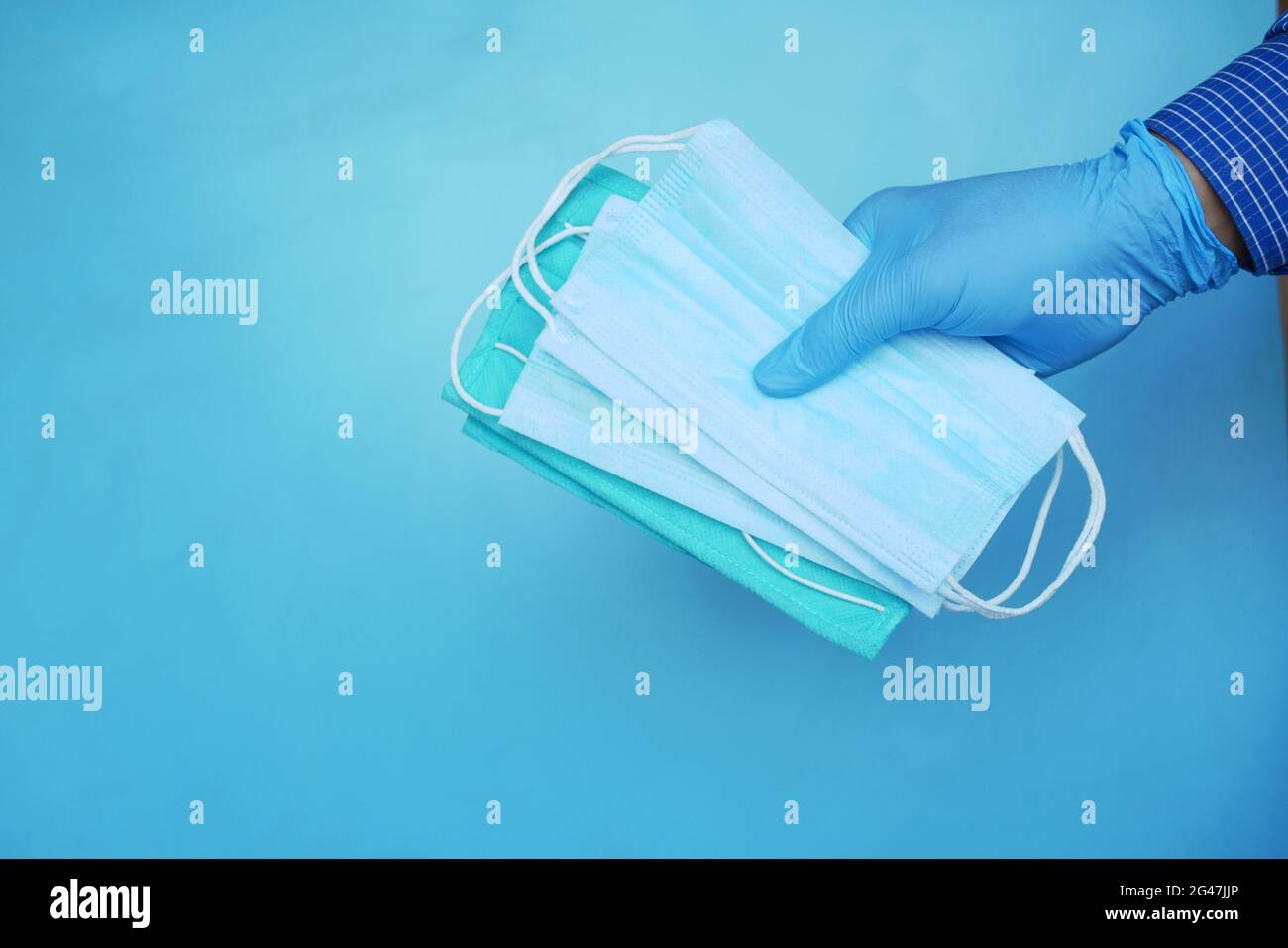 hand in medical glovers holding surgical face mask Stock Photo - Alamy