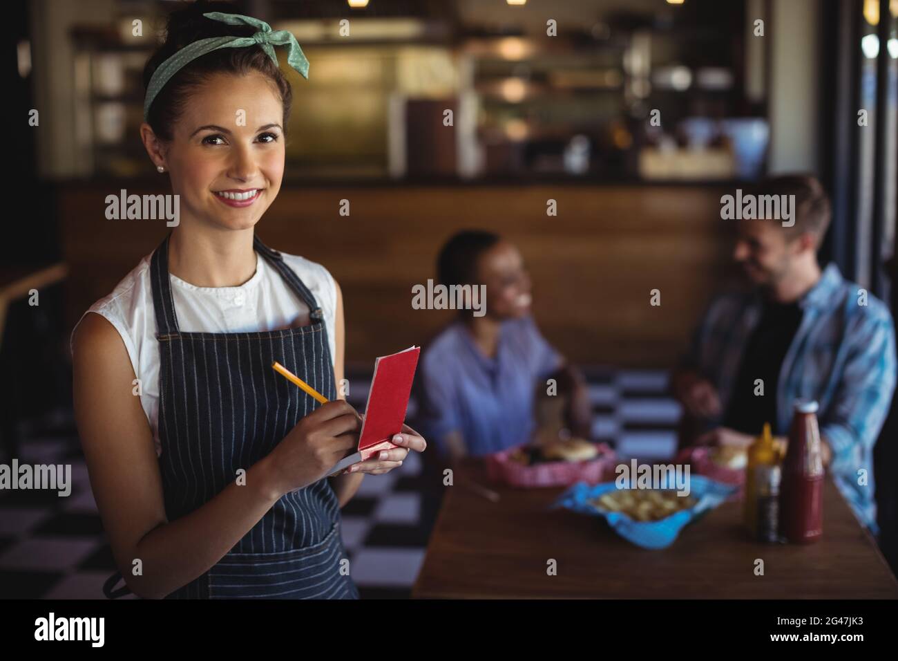 Waitress taking order at restaurant Stock Photo - Alamy