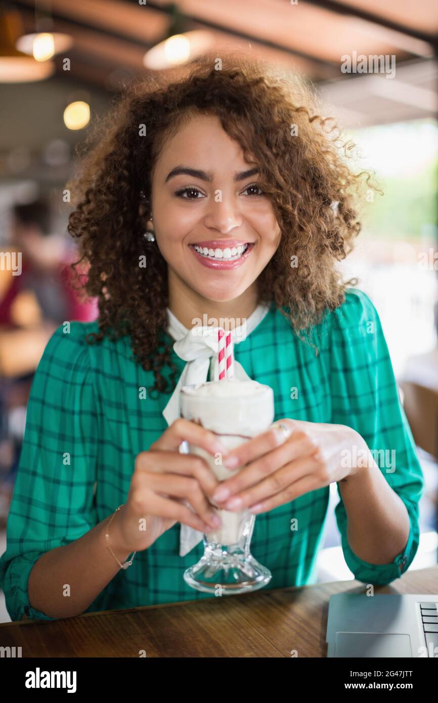 Portrait happy woman drinking milkshake hi-res stock photography and ...