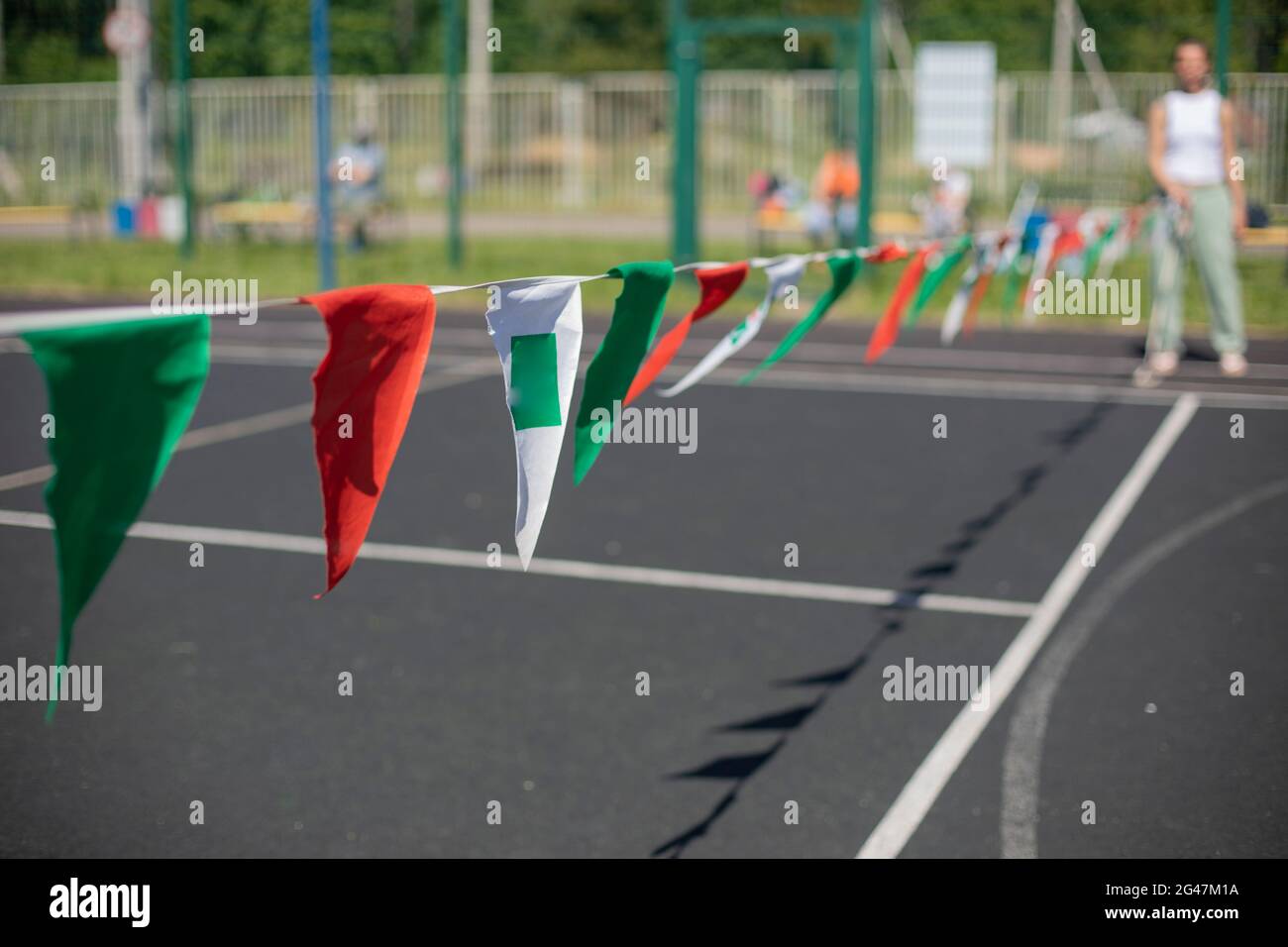 Flags on a rope. Sports tape. A fenced sports ground for the tournament ...