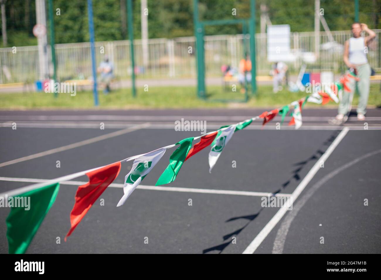 Flags on a rope. Sports tape. A fenced sports ground for the tournament ...