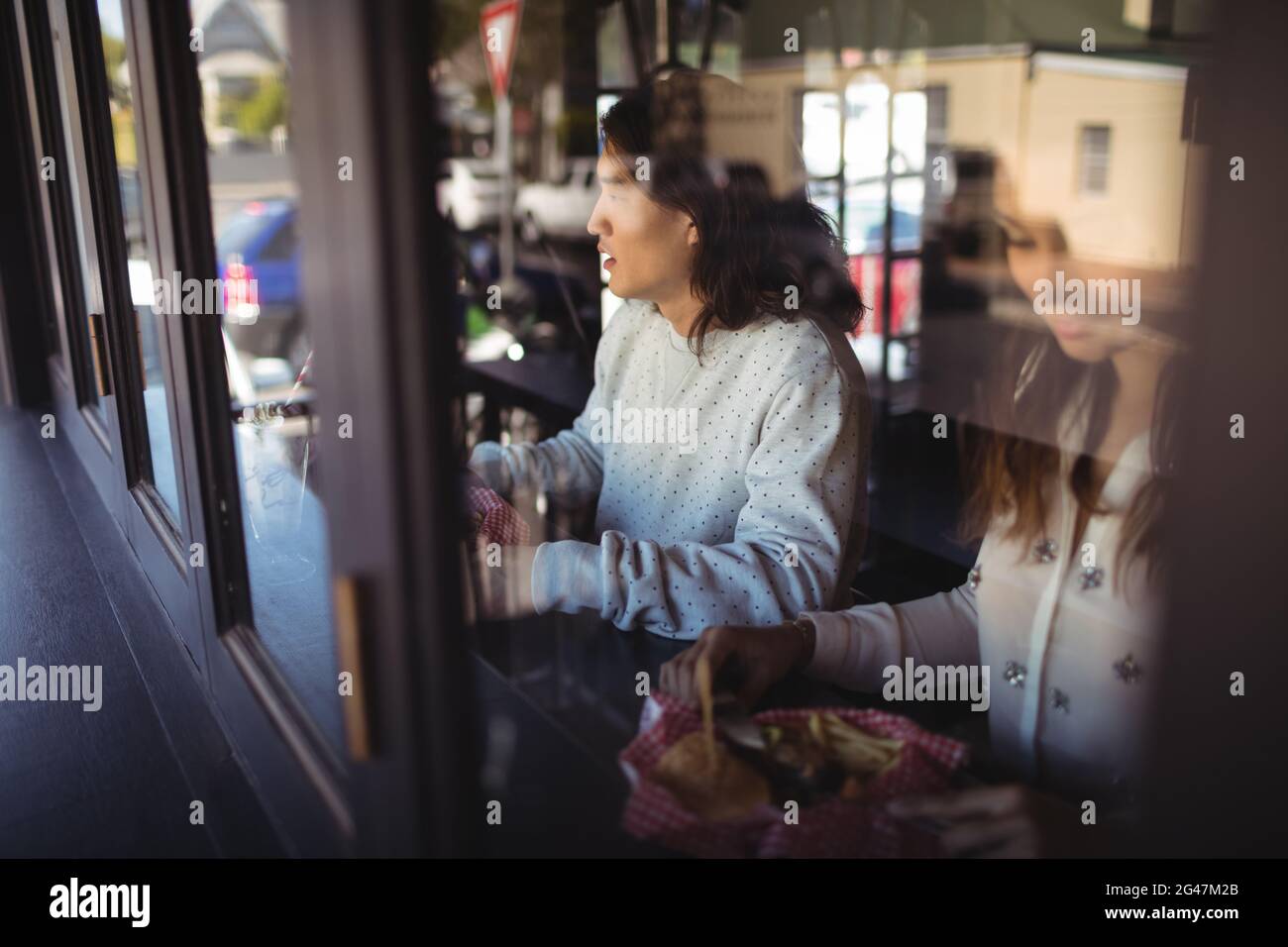 Friends having burger together Stock Photo - Alamy
