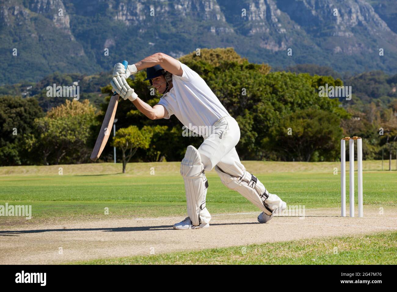 Full length of cricketer playing on field Stock Photo - Alamy