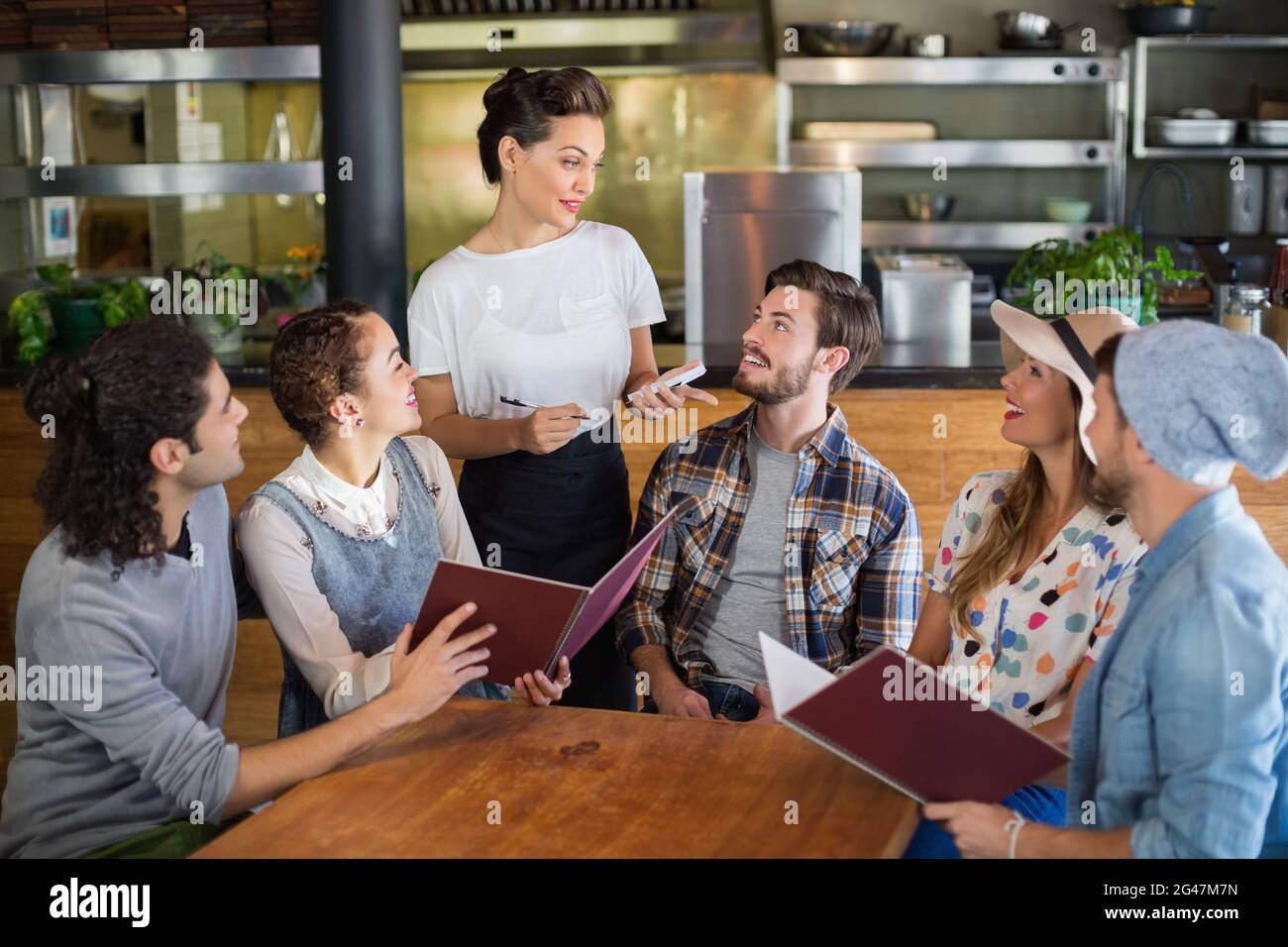 Waitress woman talking friend hi-res stock photography and images - Alamy
