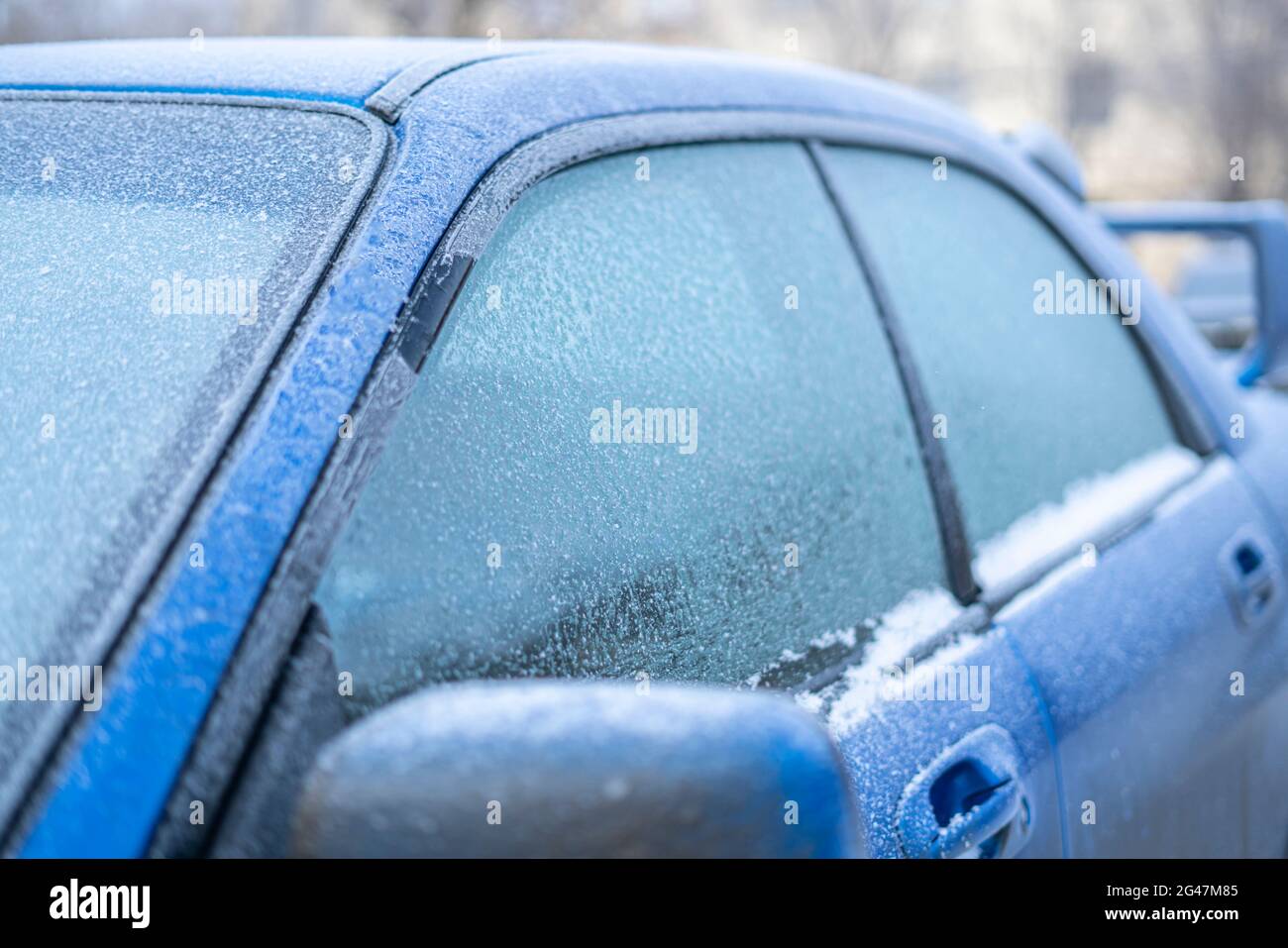 car window glass under the frozen ice, cold winter problems concept ...