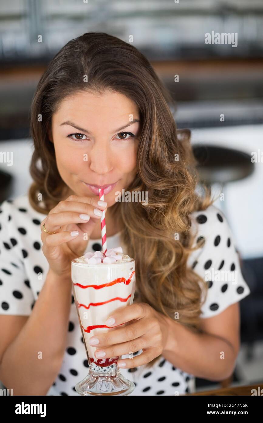 Portrait of woman having drink Stock Photo - Alamy