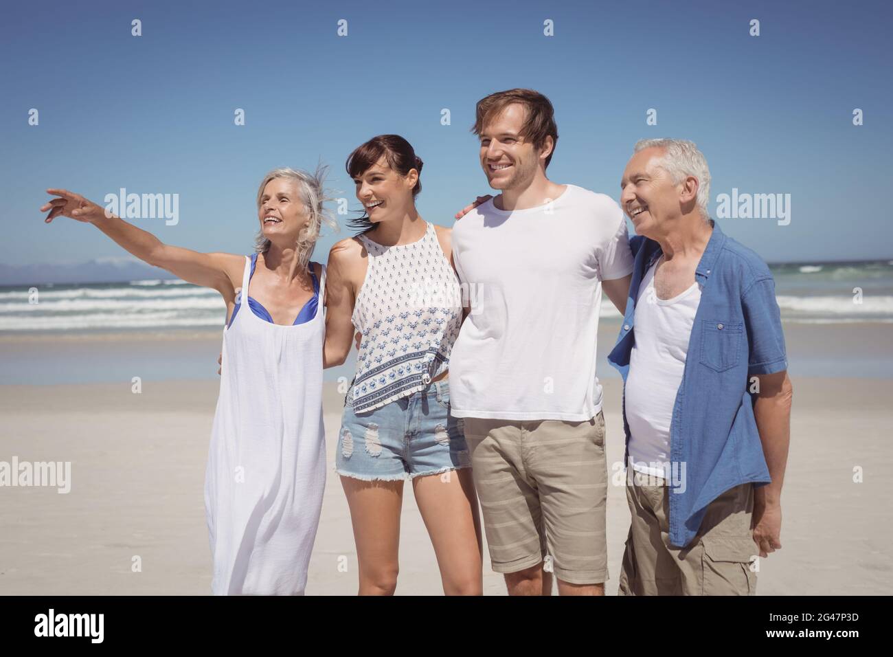 Happy family looking away while standing side by side Stock Photo - Alamy