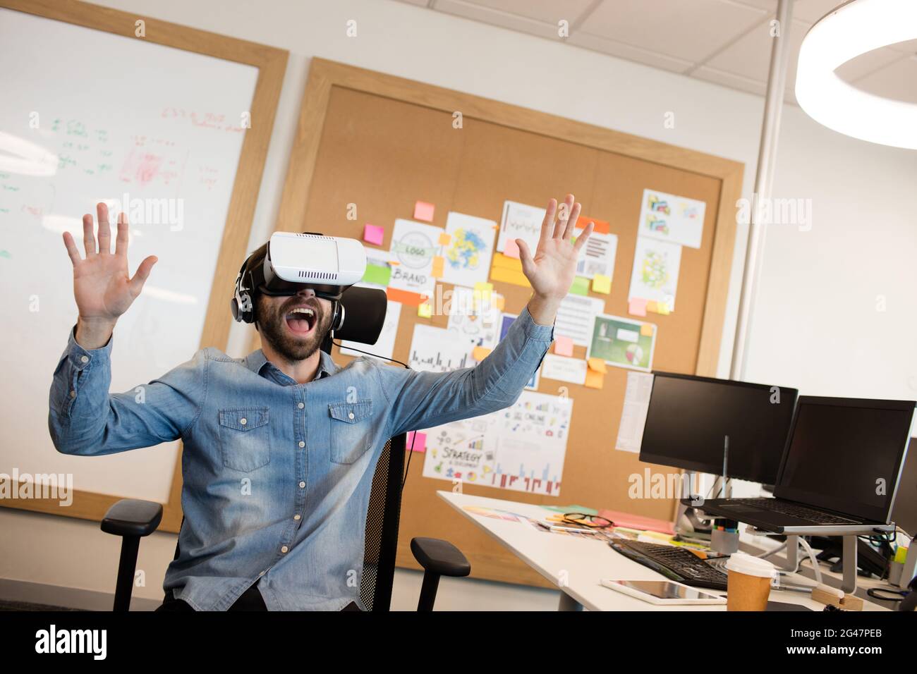 Businessman screaming while experiencing virtual reality Stock Photo ...