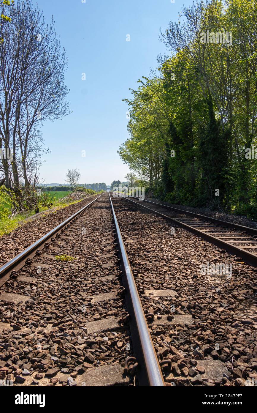 perspective view of converging railway lines of train tracks near ...
