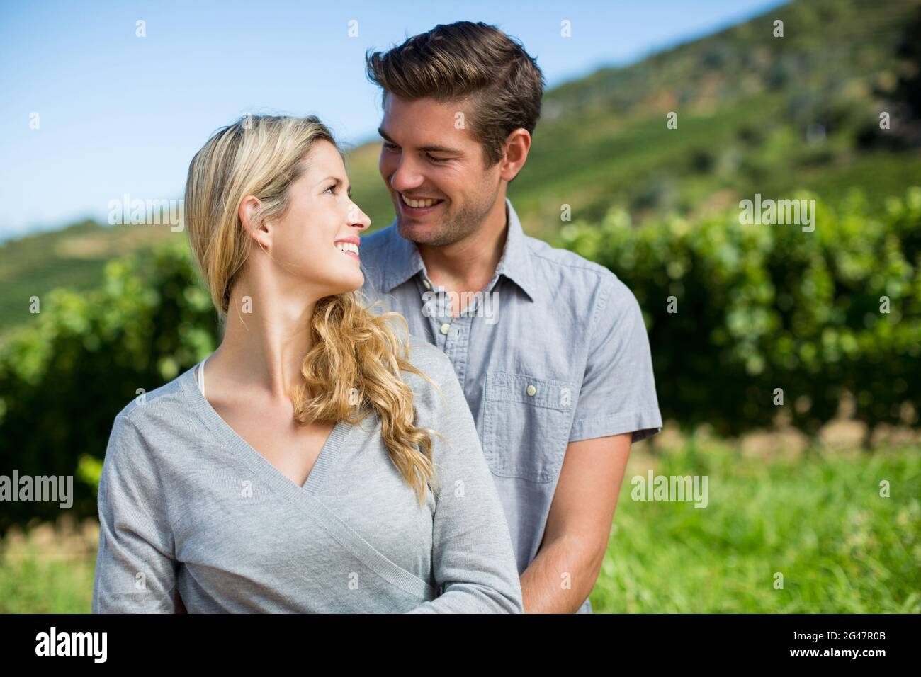 Happy young couple looking at each other Stock Photo - Alamy