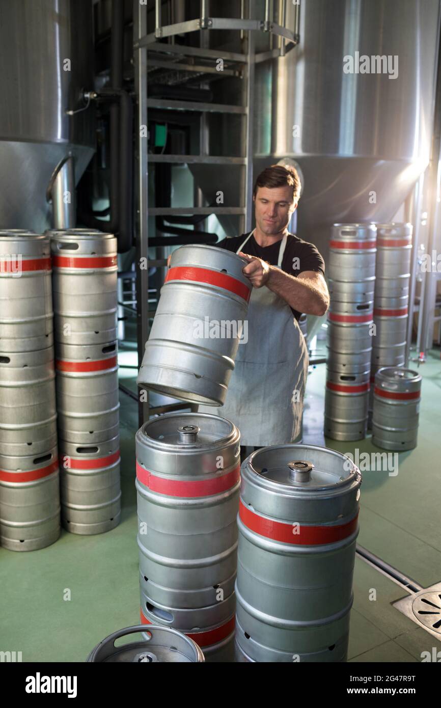 Male worker arranging kegs Stock Photo - Alamy