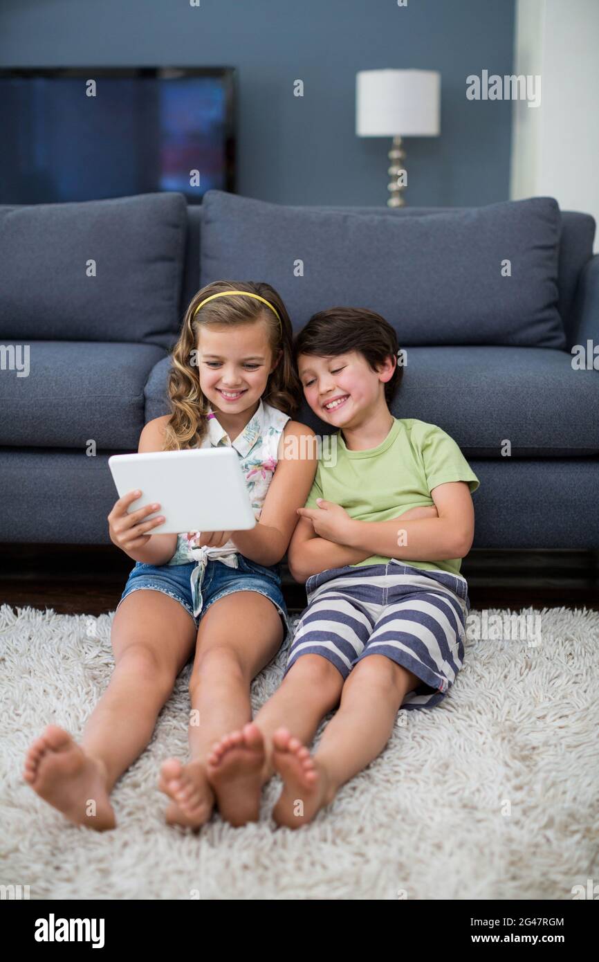 Happy siblings using digital hi-res stock photography and images - Alamy