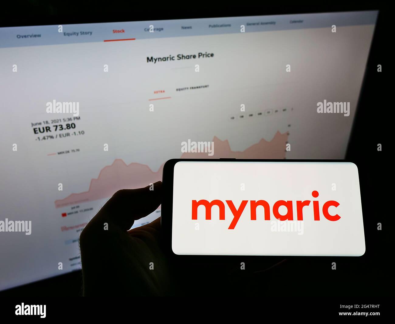 Person holding smartphone with logo of German laser equipment ...