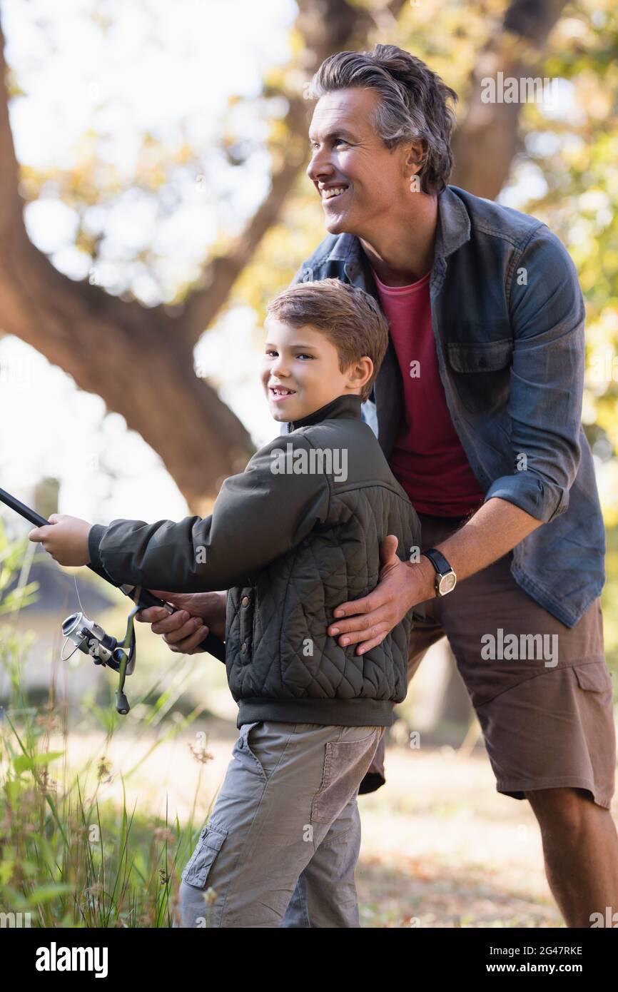 Boy smiling and holding fishing rod hi-res stock photography and images ...
