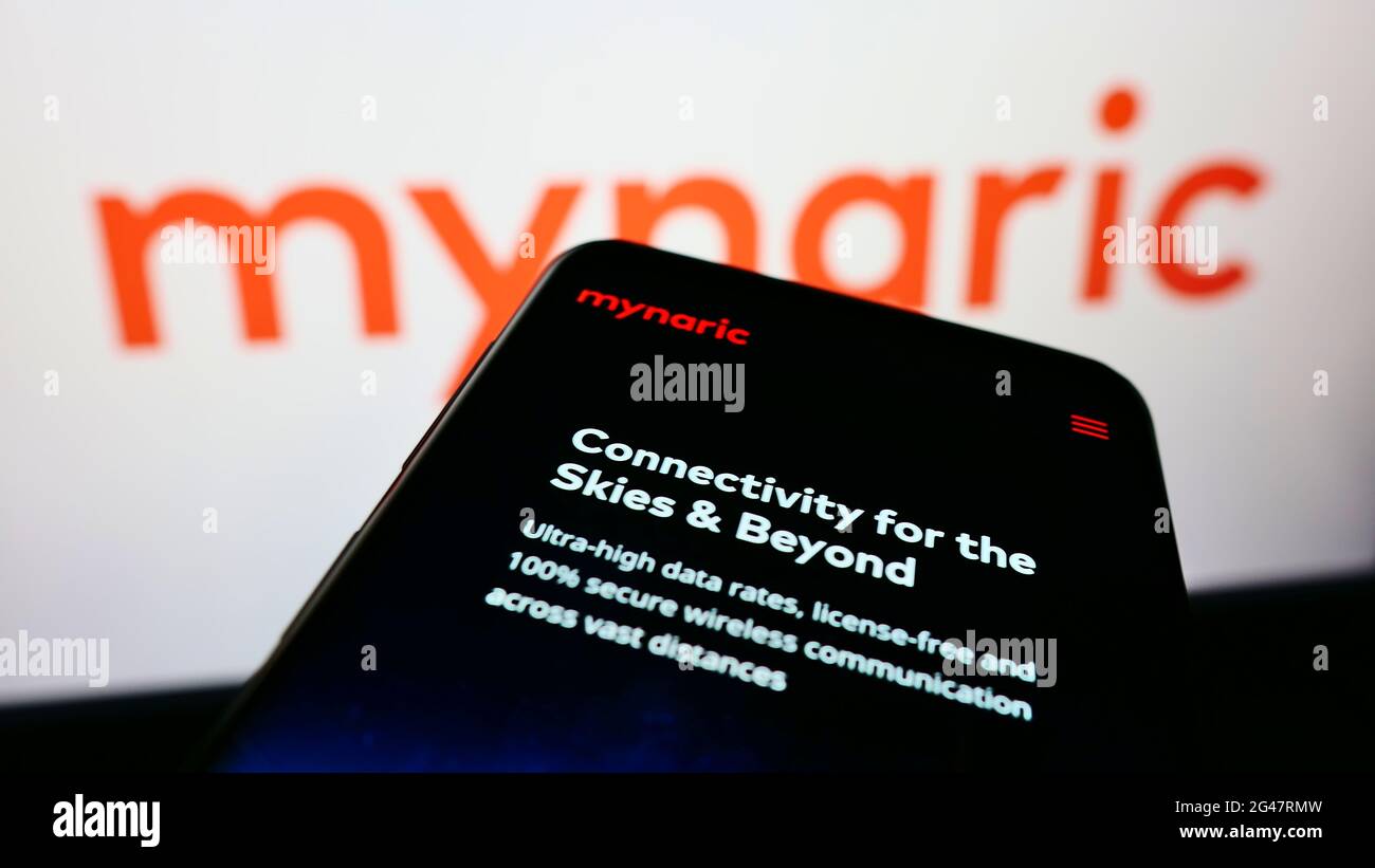 Person holding cellphone with website of German laser equipment ...