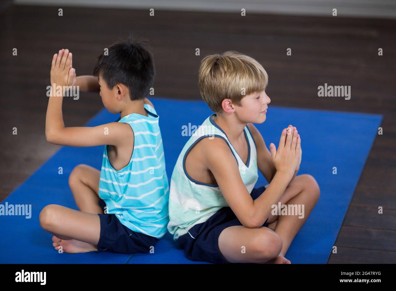 Siblings performing yoga at home Stock Photo - Alamy