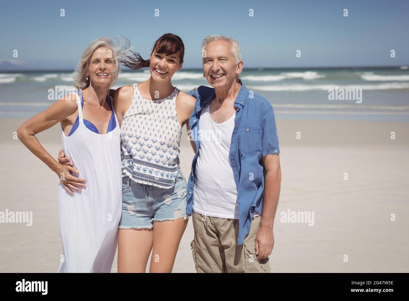 Portrait of family standing at beach Stock Photo - Alamy