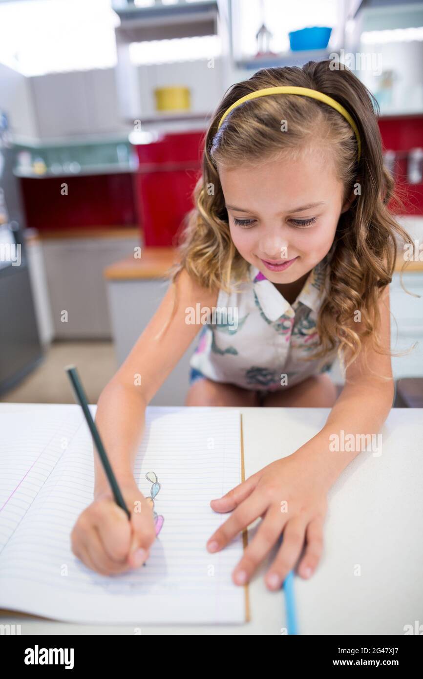 Girl sitting kitchen table writing hi-res stock photography and images ...