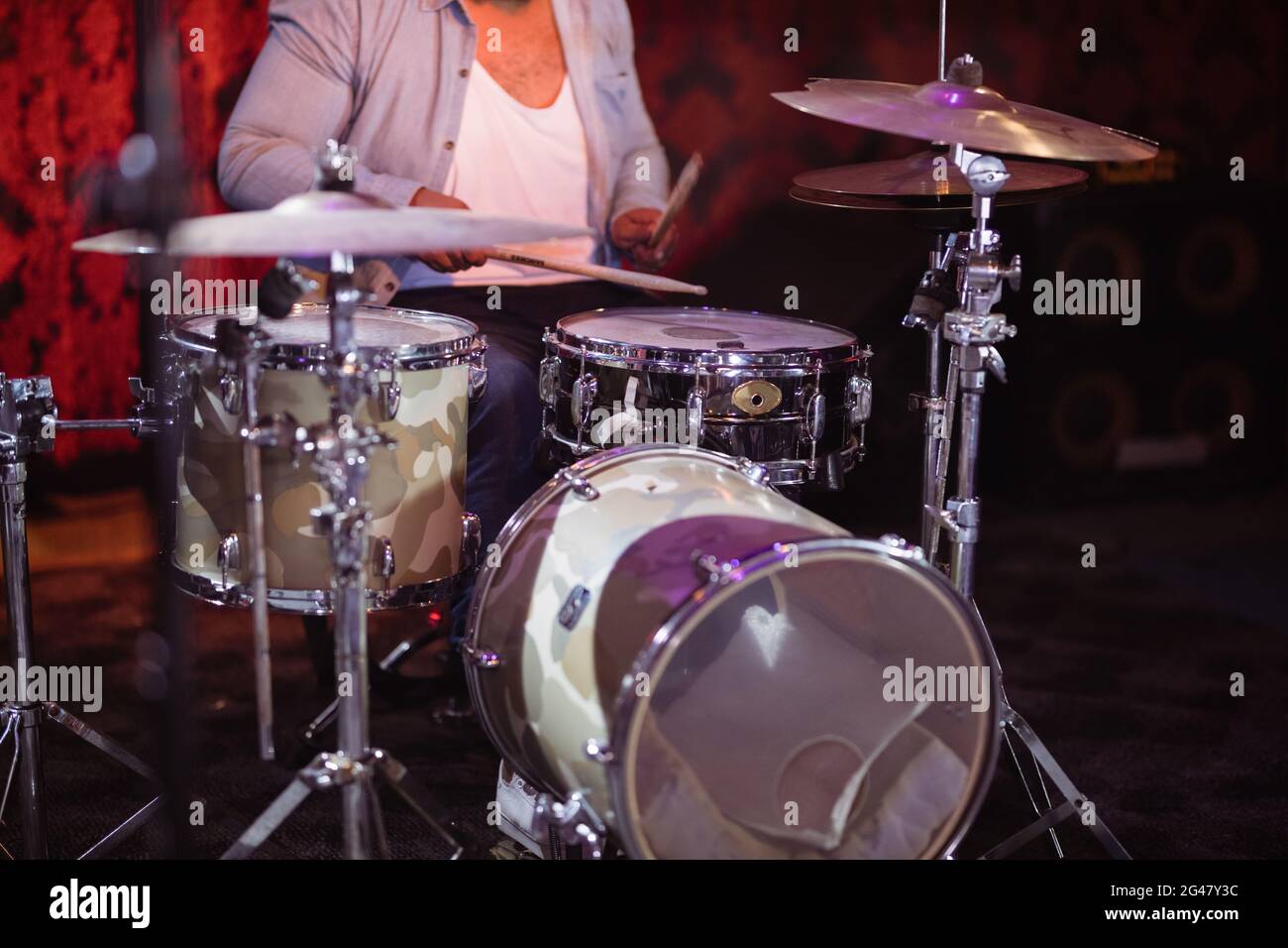 Mid section of drummer performing on stage at nightclub Stock Photo - Alamy