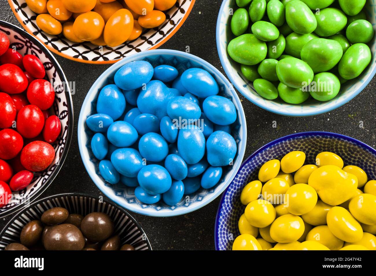 M&M's candy on the black background in bowls, colorful candy ...