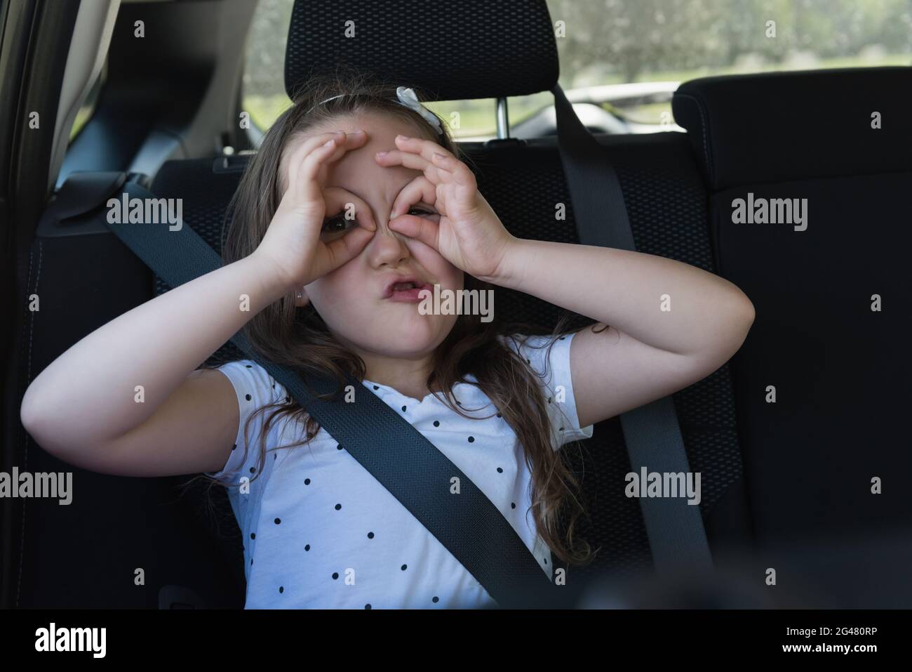 Playful girl making funny face Stock Photo - Alamy