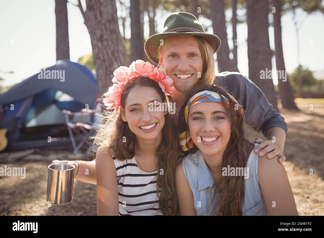 Portrait of smiling friends against tent camping at forest Stock Photo ...