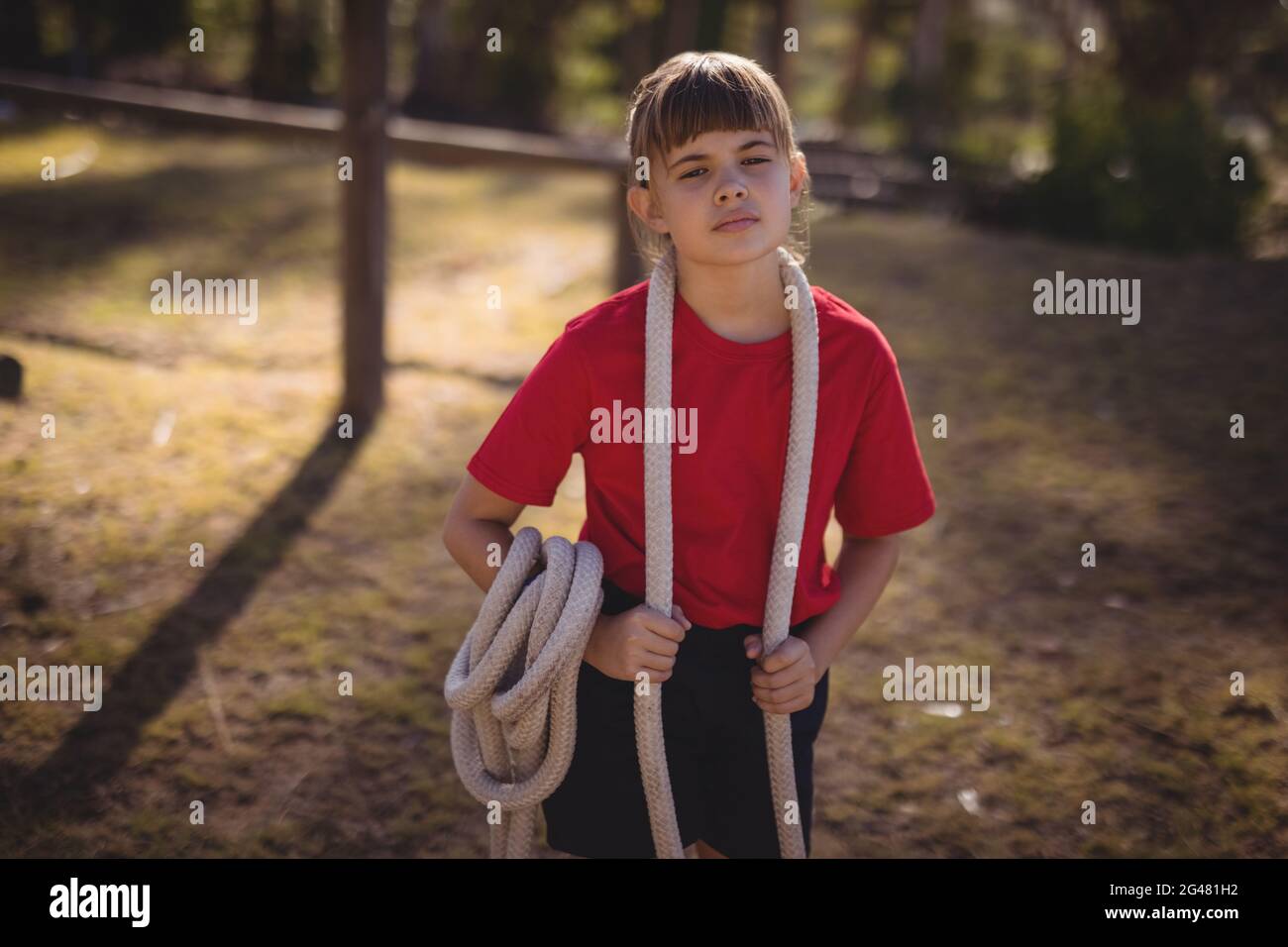 Confident girl standing with rope around her neck Stock Photo - Alamy