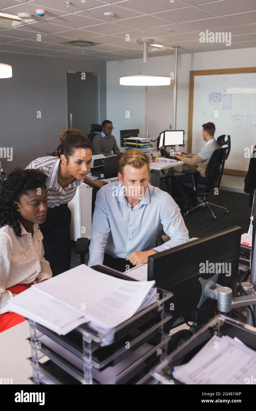 Business colleagues looking at desktop monitor in office Stock Photo ...