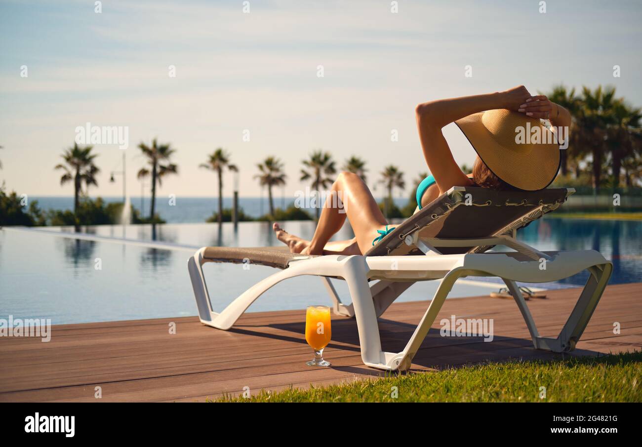 Woman lying on sunbed hi-res stock photography and images - Alamy