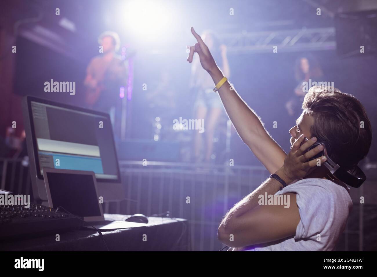 Young male dj with arms raised performing at nightclub Stock Photo - Alamy
