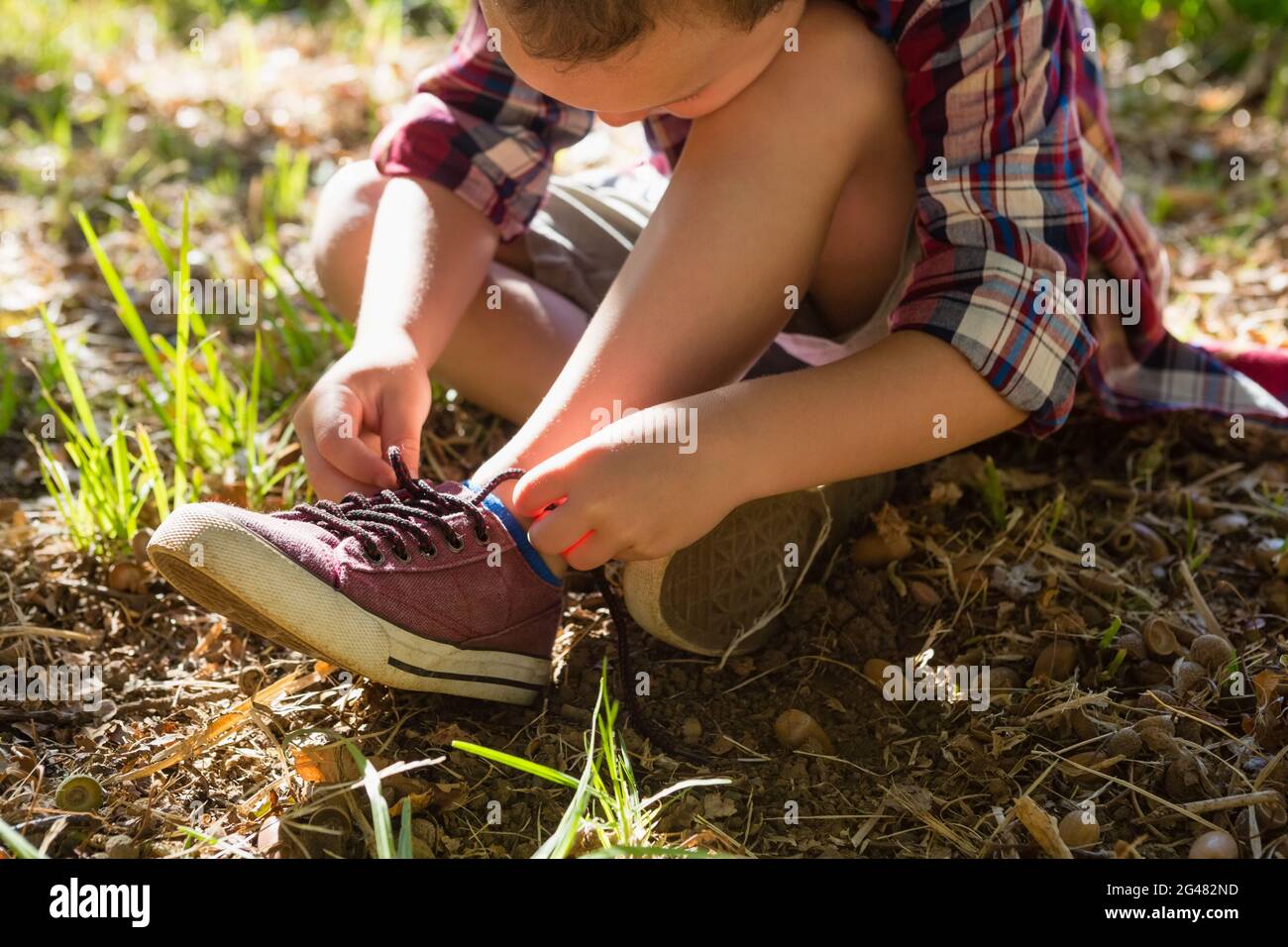 Boy tying shoe hi-res stock photography and images - Alamy