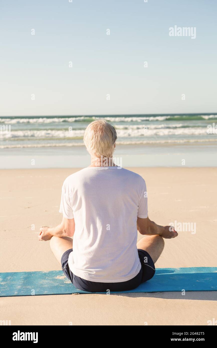 Rear view man meditating sitting hi-res stock photography and images ...