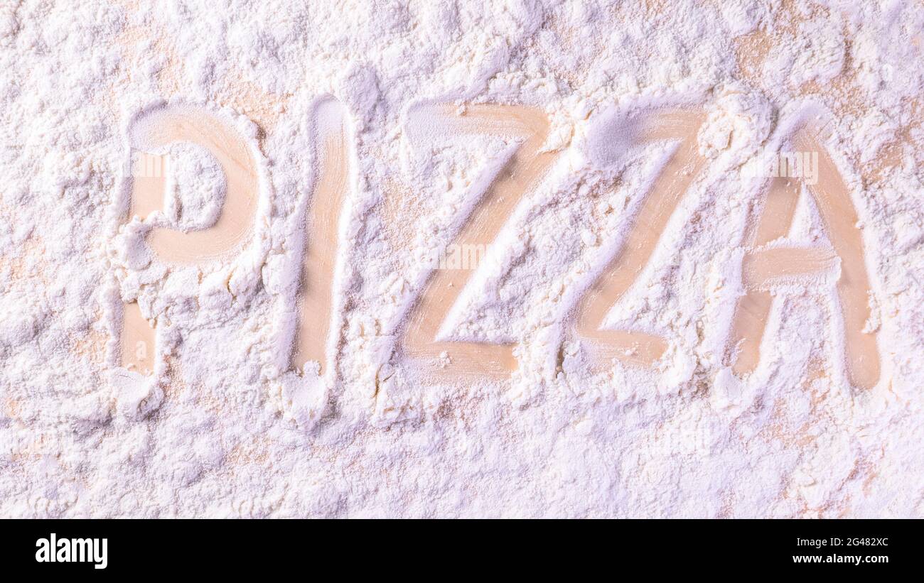 lettering flour the word pizza. making pizza Stock Photo - Alamy