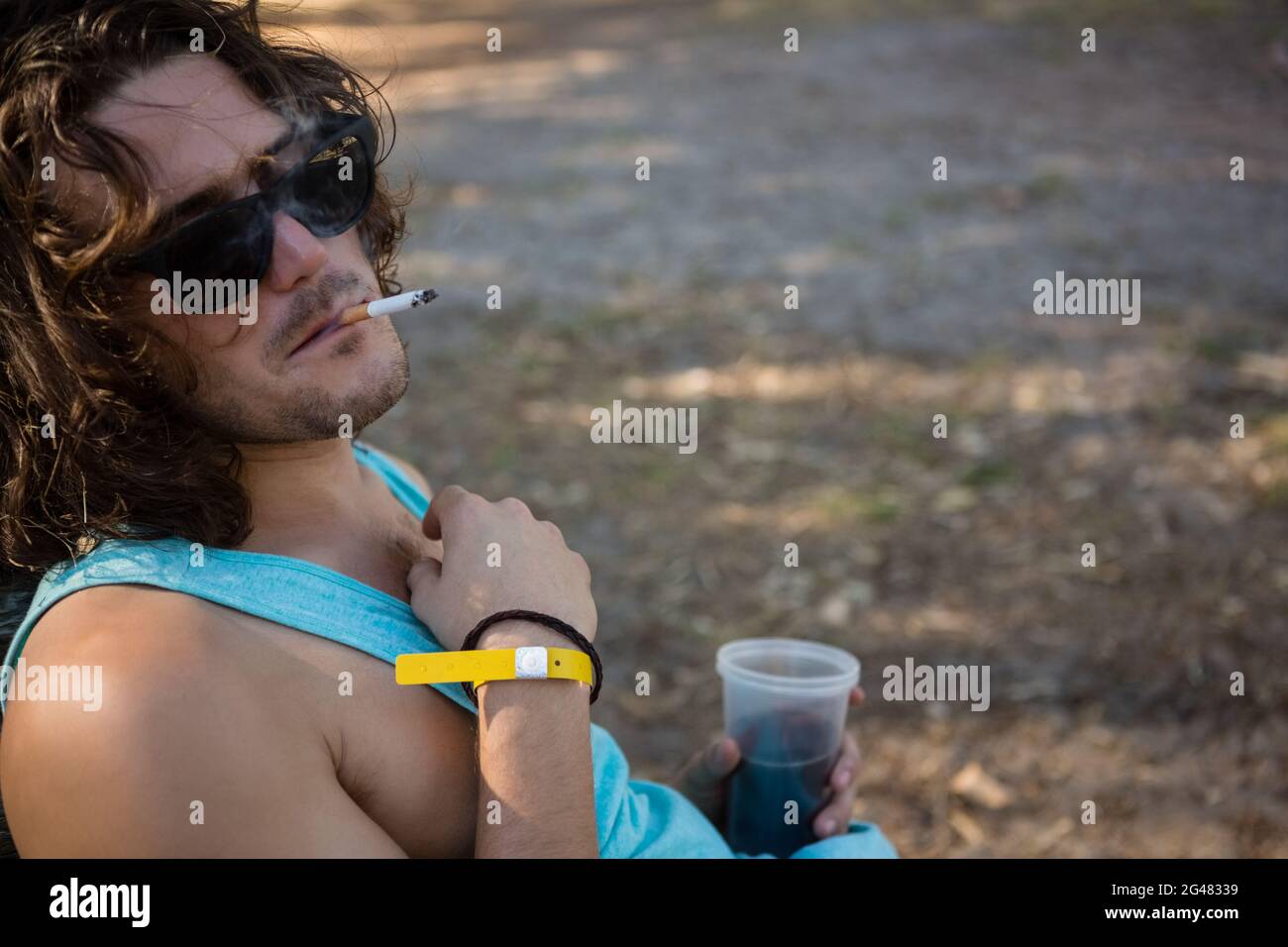 Man smoking cigarette in the park Stock Photo - Alamy