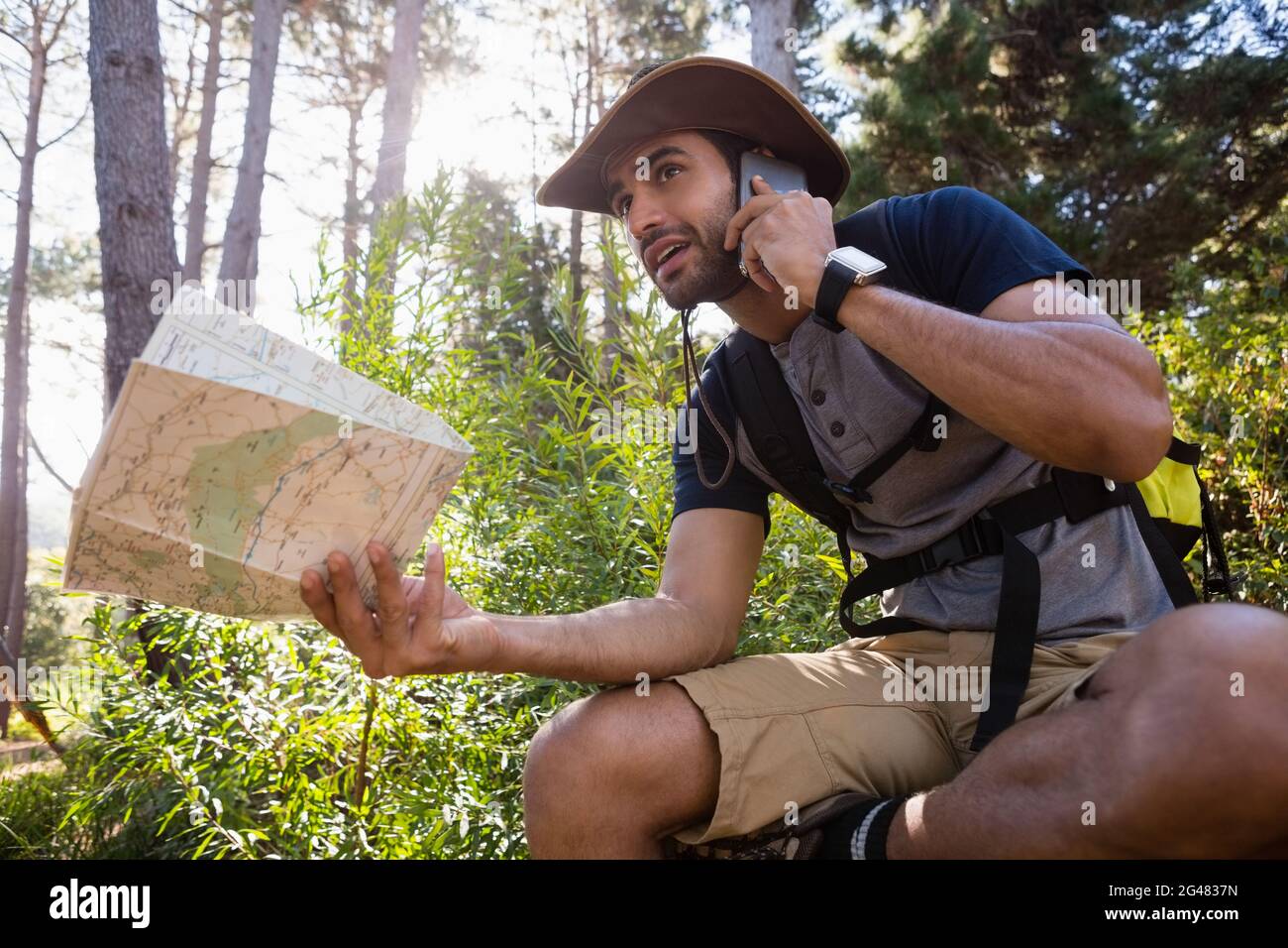 Man talking on the mobile phone while holding the map Stock Photo - Alamy