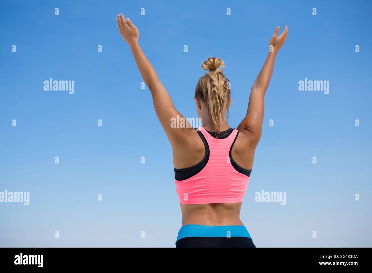 Woman arms raised rear view sky hi-res stock photography and images - Alamy