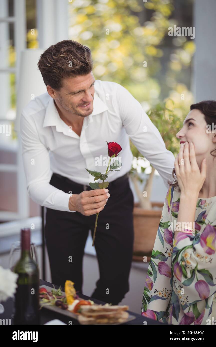 Man offering rose to woman Stock Photo - Alamy