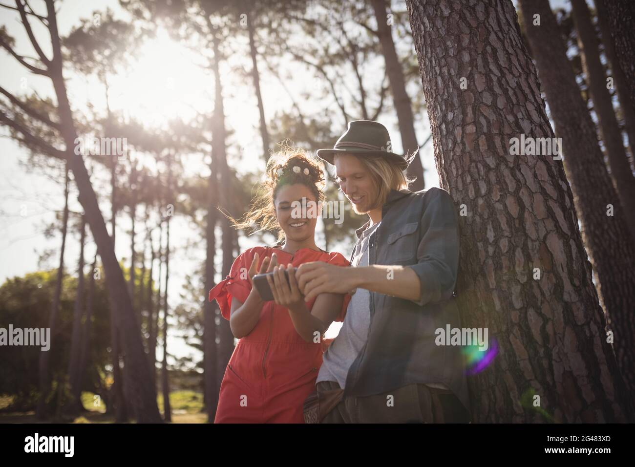 Young couple using mobile phone together Stock Photo - Alamy