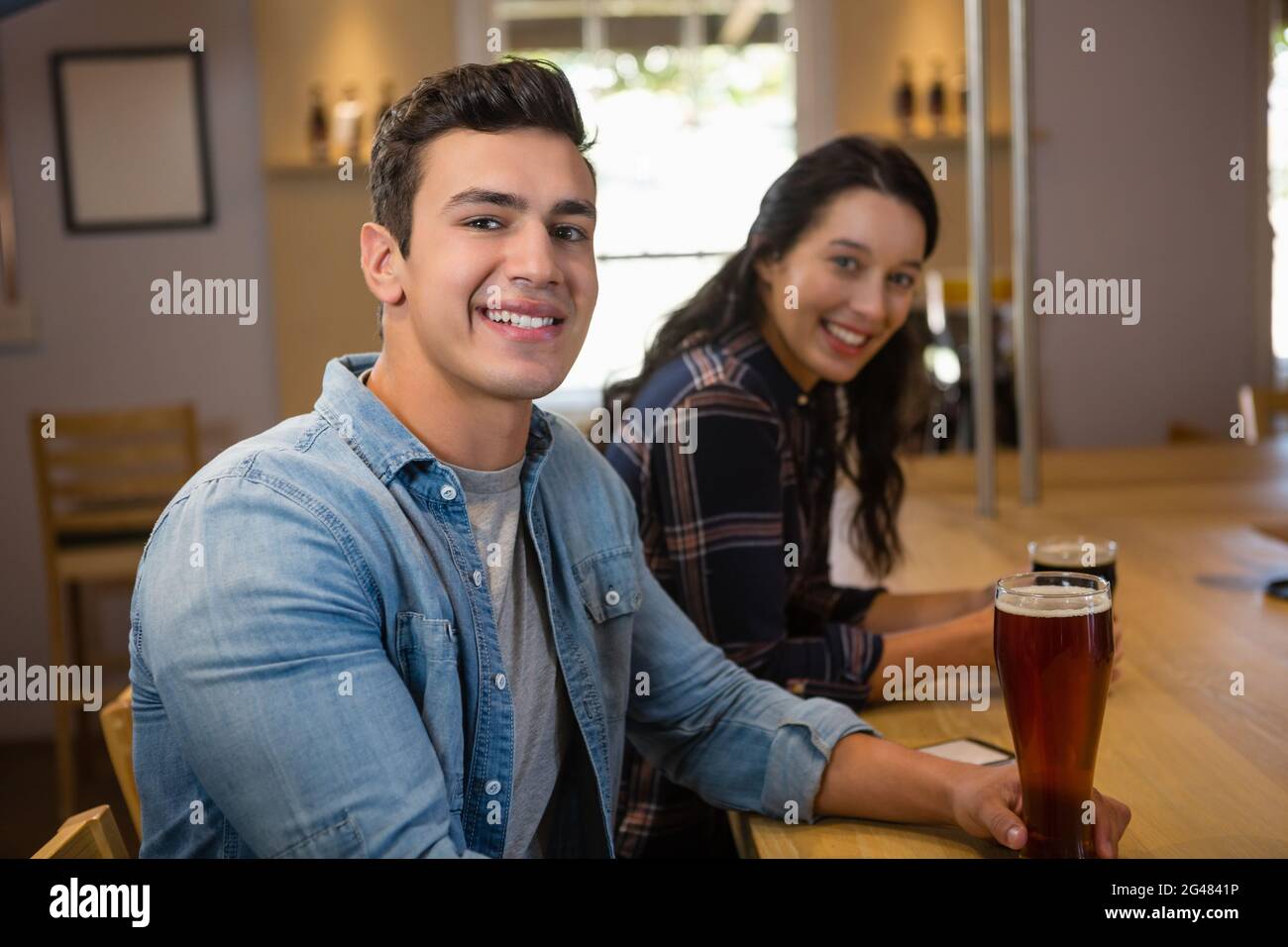 Woman holding two drinks bar hi-res stock photography and images - Alamy