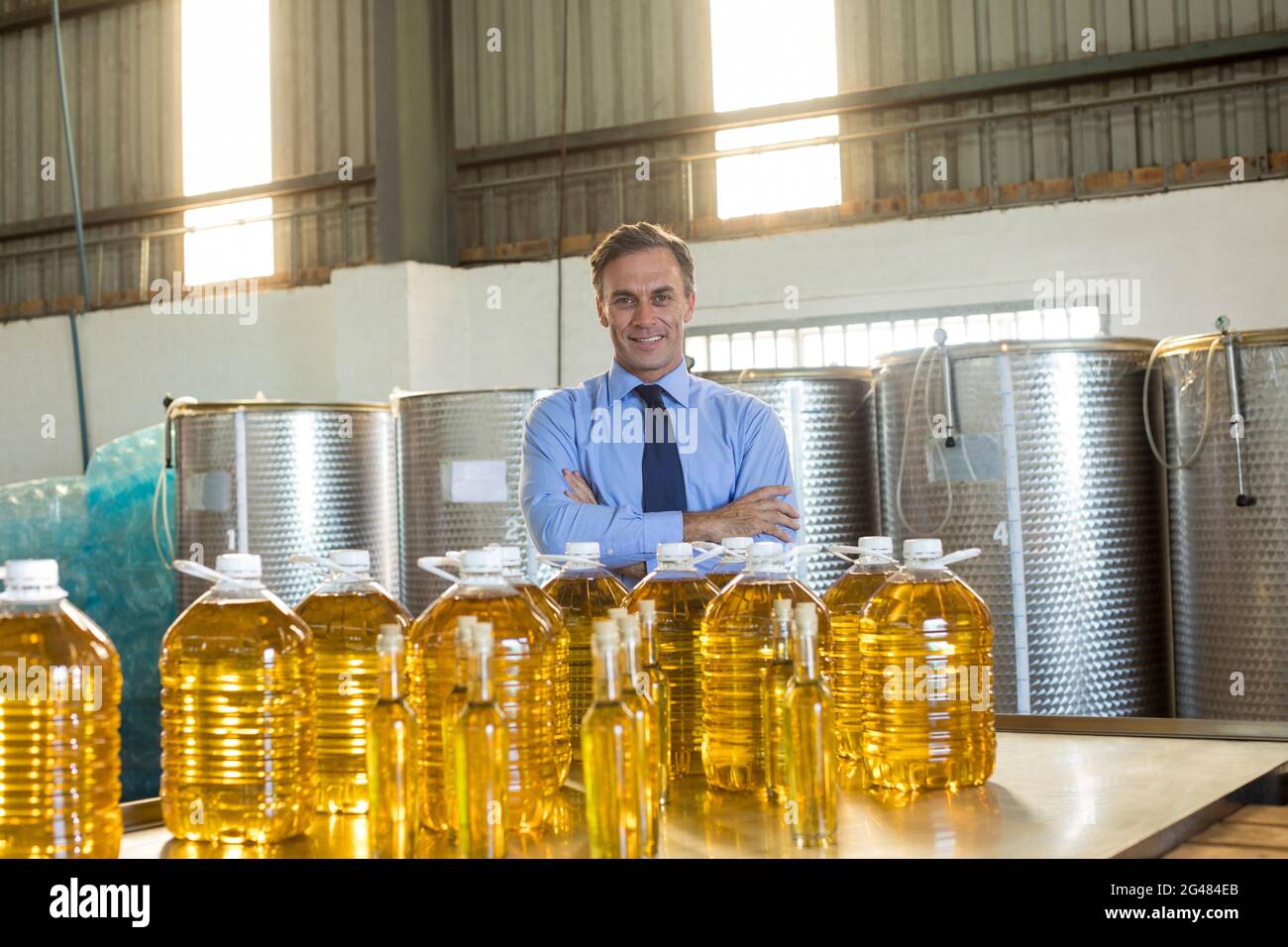 Portrait of manager standing with arms crossed Stock Photo - Alamy