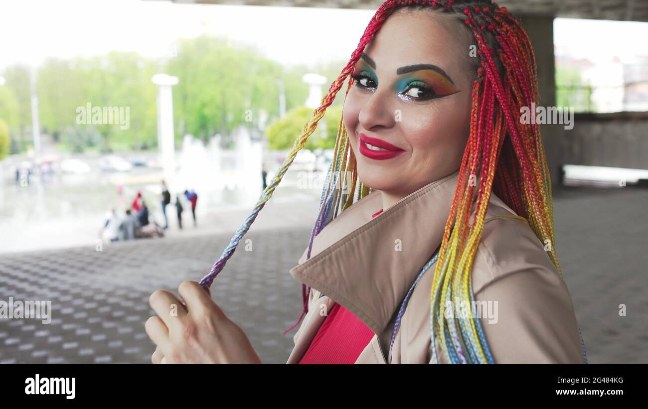 Fashionable girl in an elegant beige jacket with multi-colored African ...