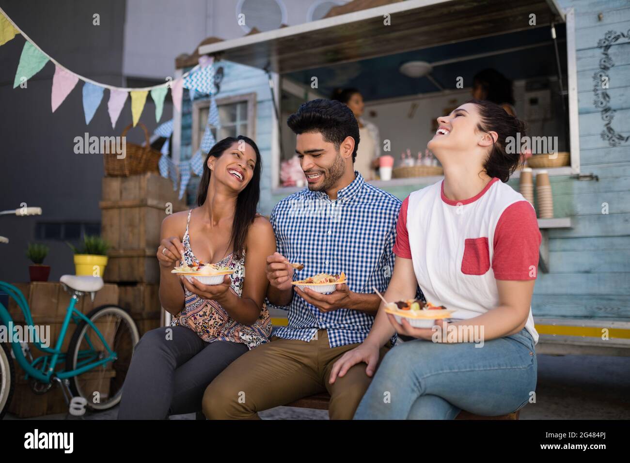 Happy friends talking eating snacks hi-res stock photography and images ...