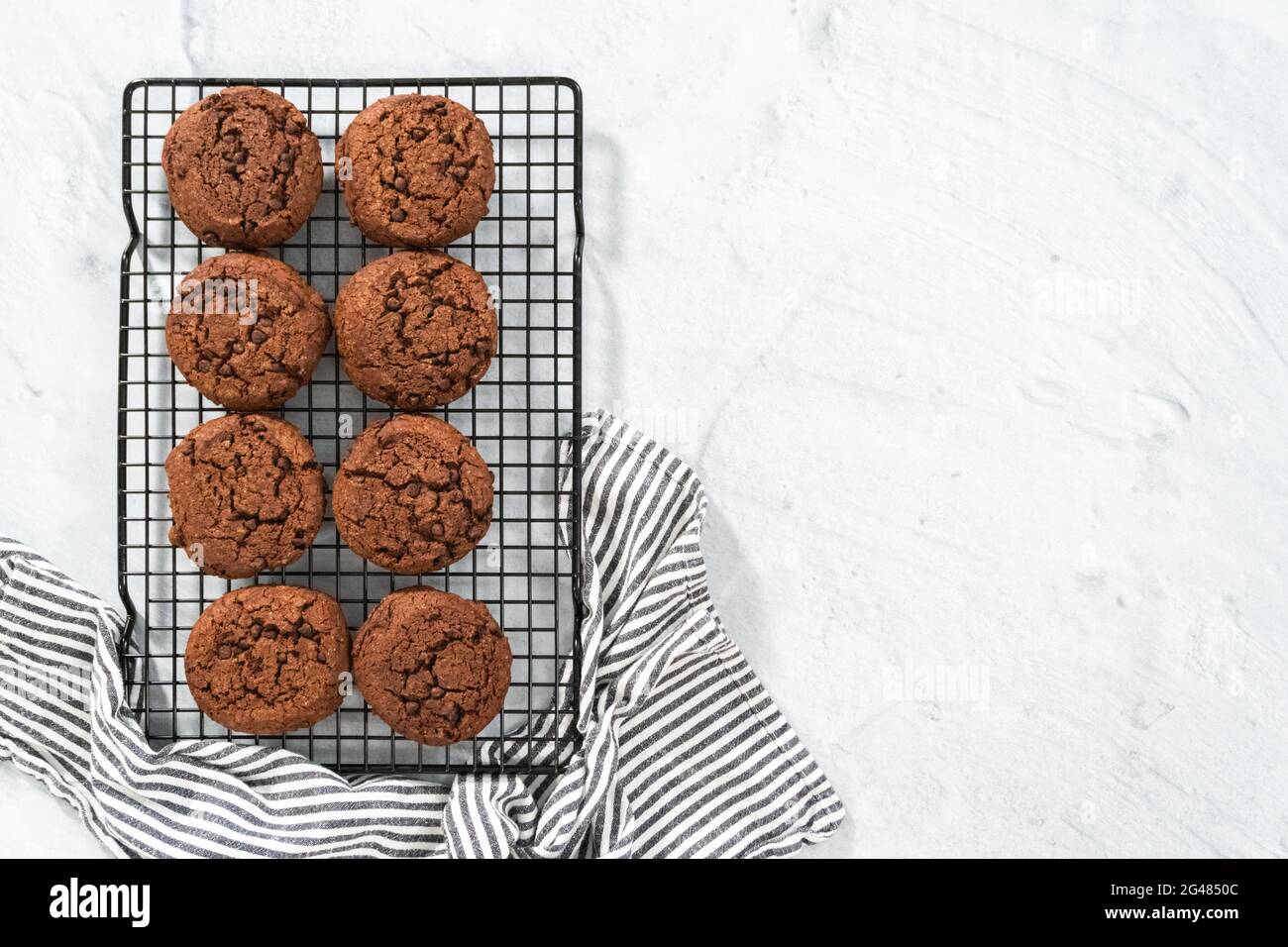 Flat lay. Freshly baked double chocolate chip cookies on a cooling rack ...