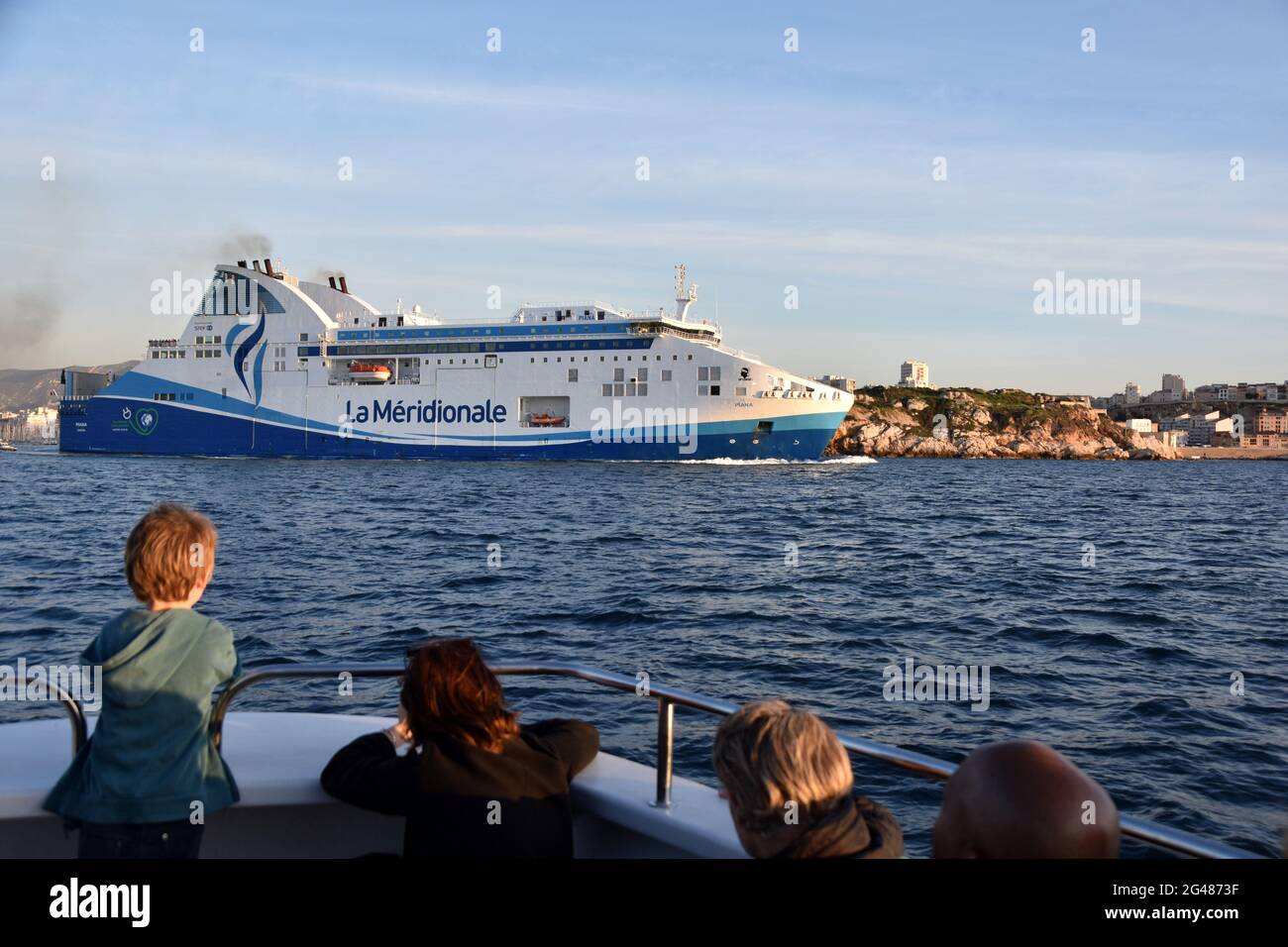 Marseille, France. 18th June, 2021. People on a boat watch the La ...