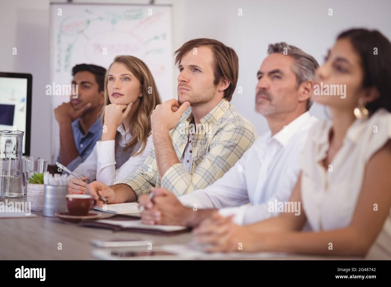 Business people sitting in conference room at office Stock Photo - Alamy