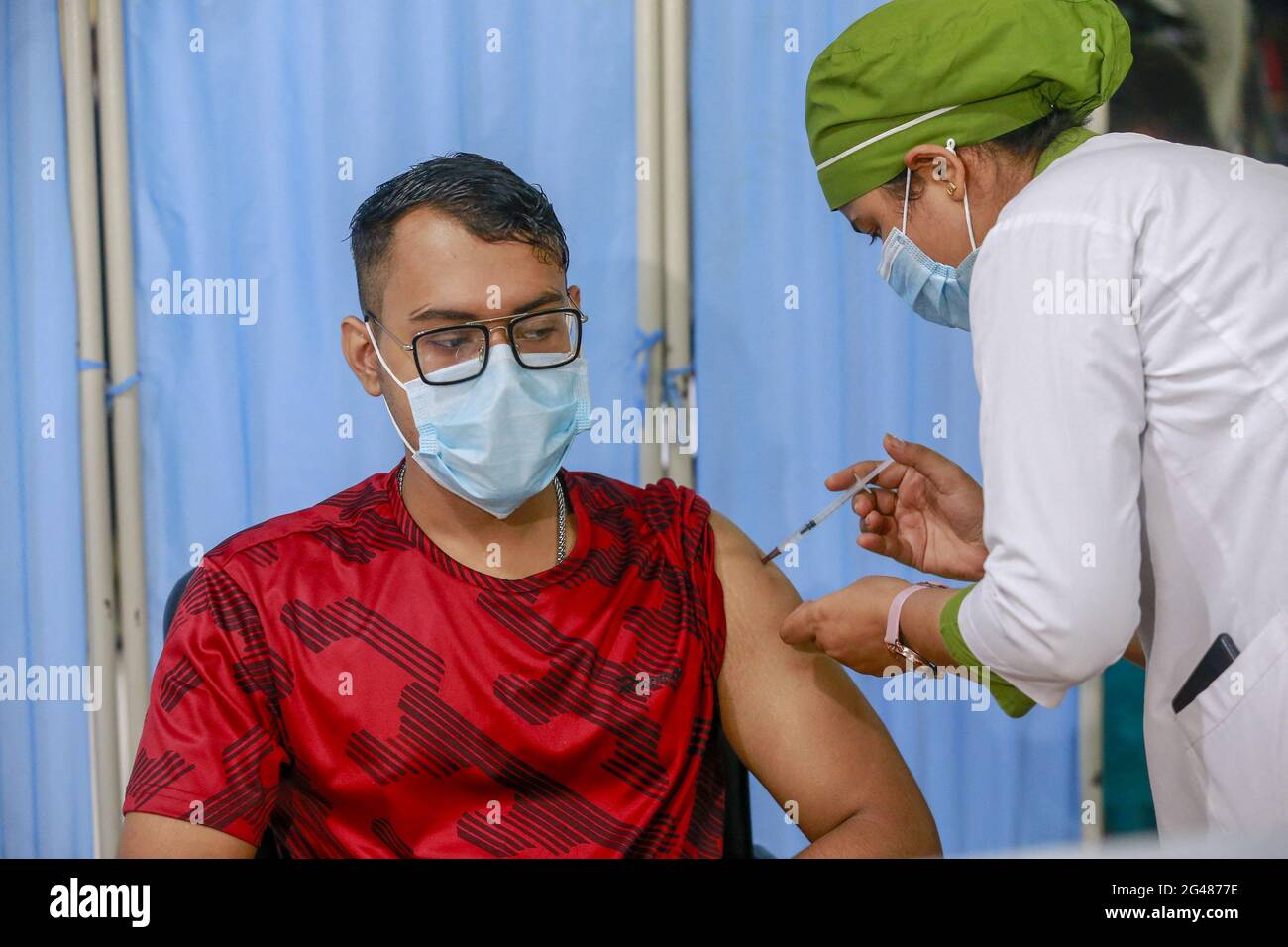 A medical student receives a dose of the Sinopharma coronavirus vaccine ...