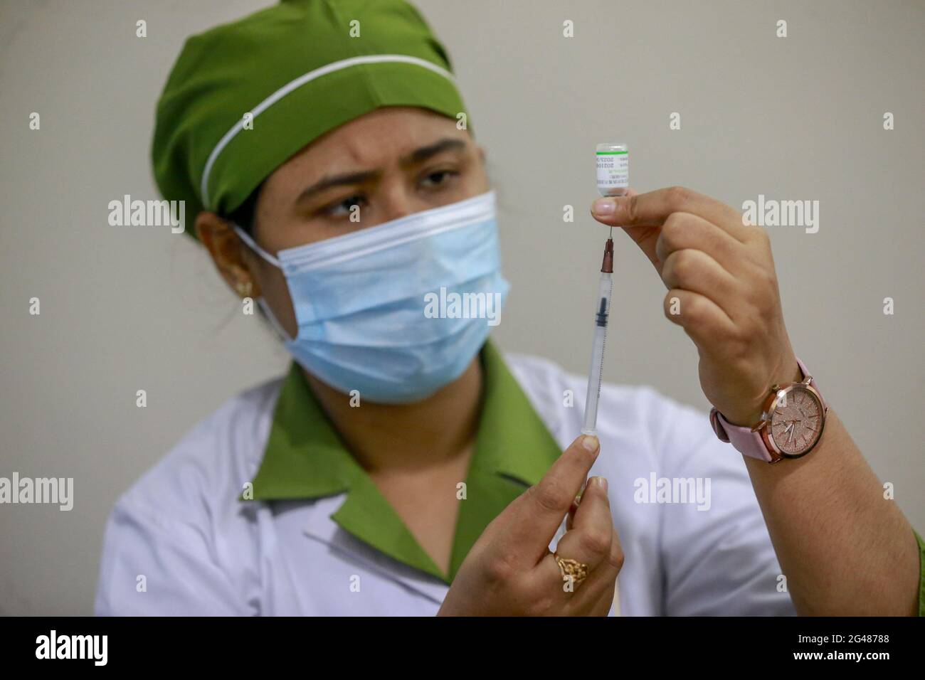A health worker prepares to administer a dose of the Sinopharma ...